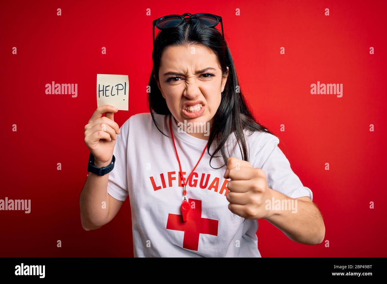 Young lifeguard woman holding paper note with help word over red ...