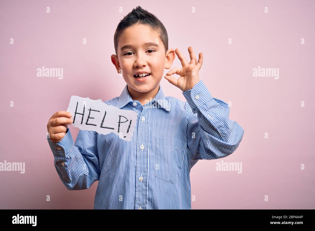 Young little boy kid holding paper sing with help message asking for ...