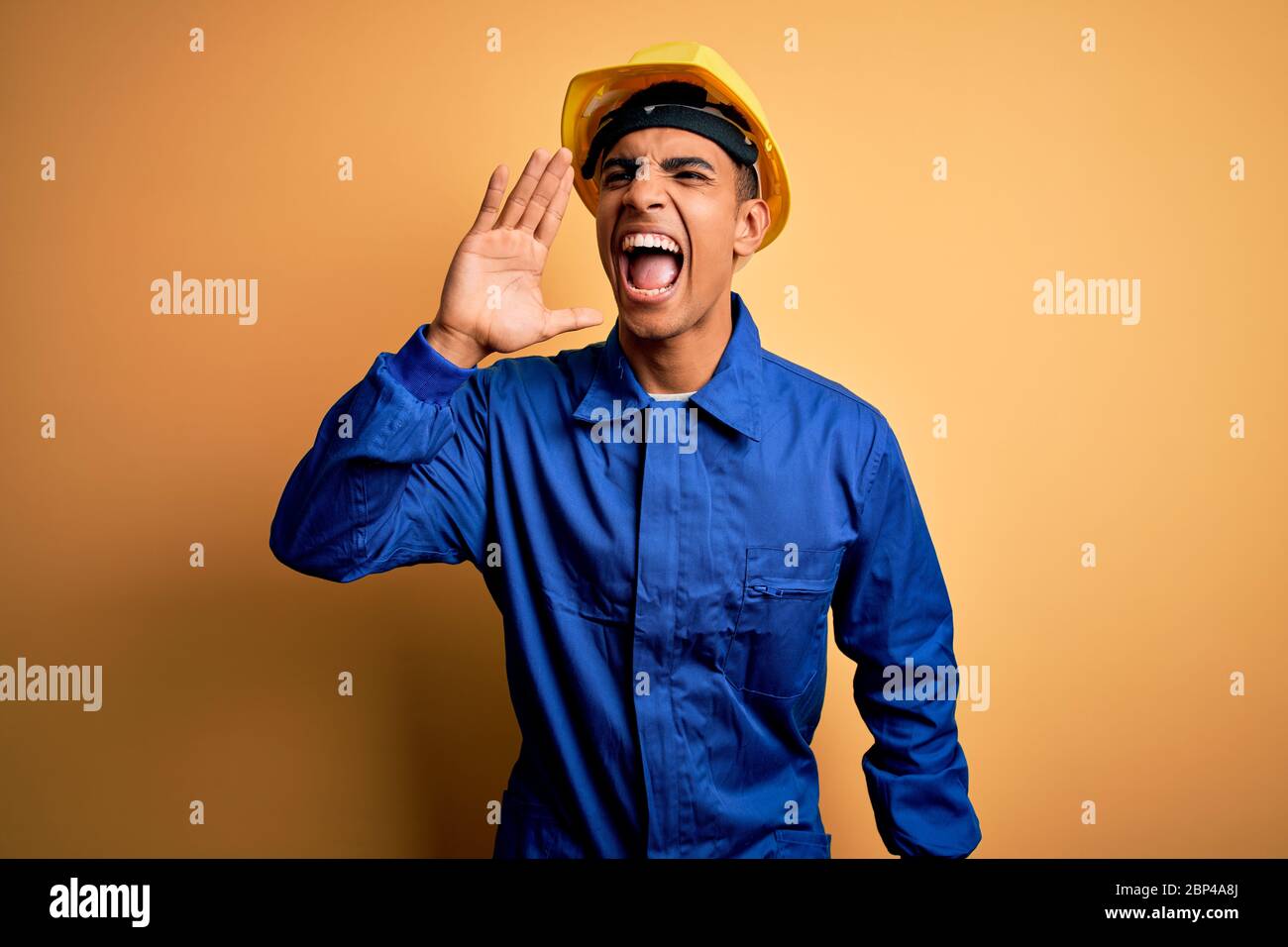 Young handsome african american worker man wearing blue uniform and ...