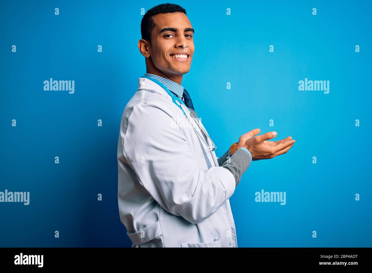 Handsome african american doctor man wearing coat and stethoscope over ...