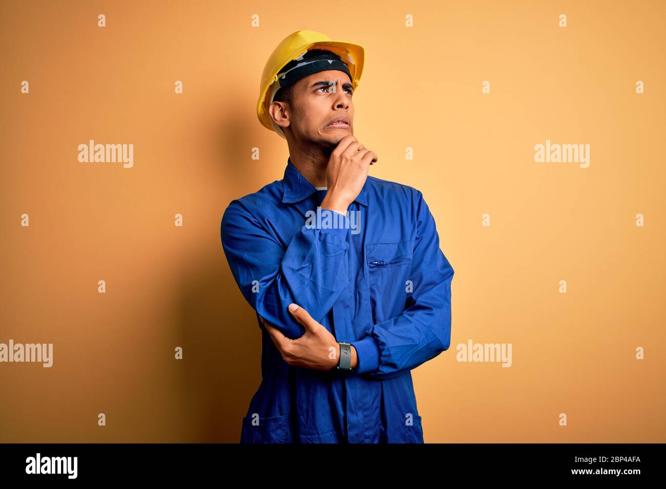 Young handsome african american worker man wearing blue uniform and ...
