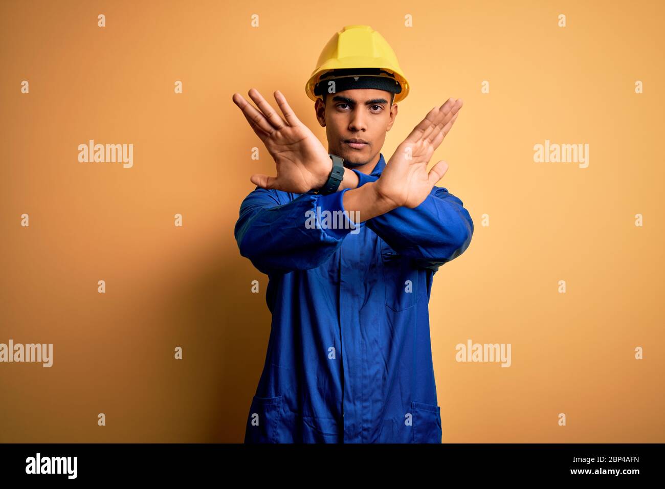 Young handsome african american worker man wearing blue uniform and ...