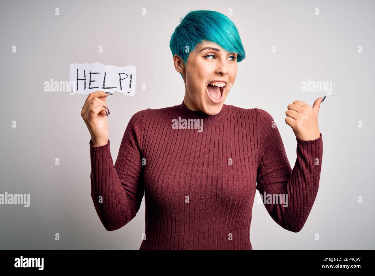 Young woman with blue fashion hair asking for help showing message on ...