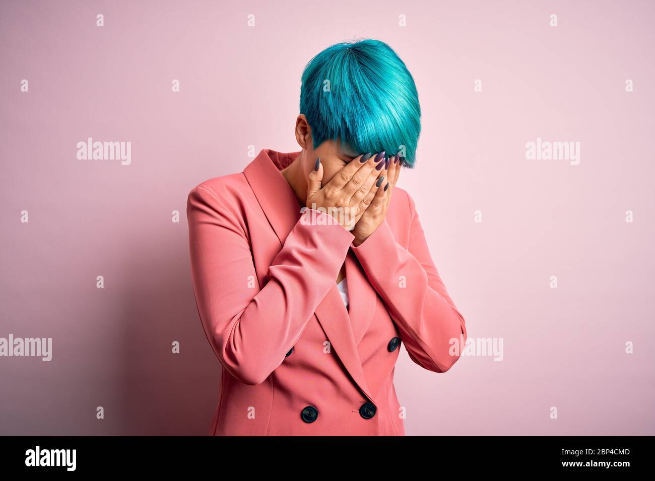 Young beautiful businesswoman with blue fashion hair wearing jacket ...