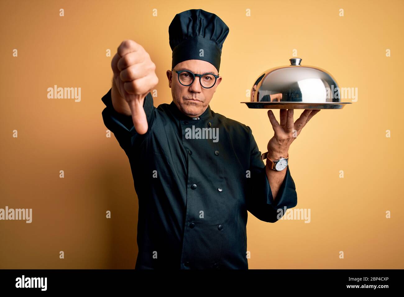 Middle age handsome grey-haired waiter man wearing cooker uniform and ...