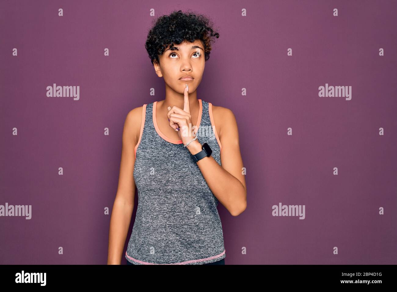 Young beautiful african american afro sportswoman doing exercise ...