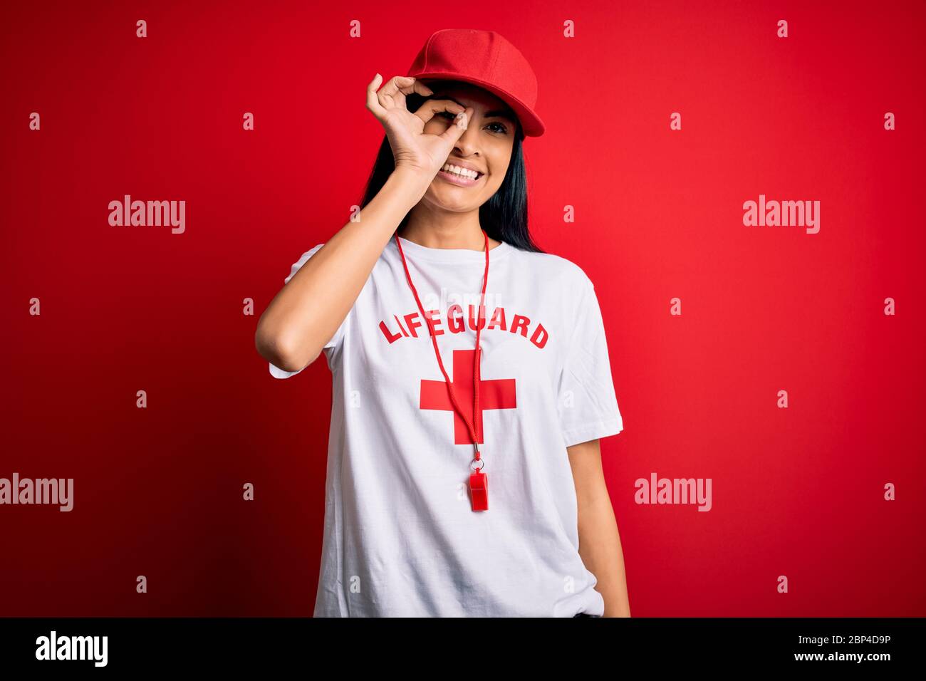 Young beautiful hispanic lifeguard woman wearing safeguard t-shirt and ...