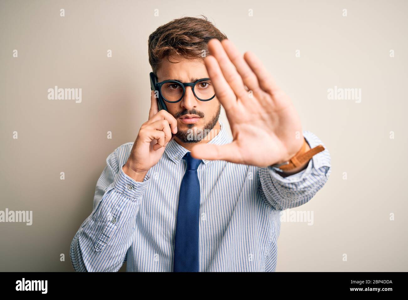 Young businessman having a conversation talking by smartphone over ...