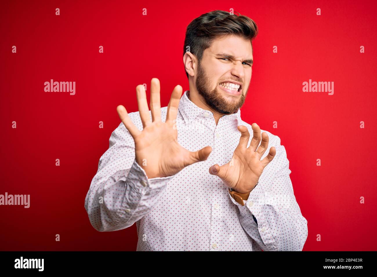 Young blond businessman with beard and blue eyes wearing elegant shirt ...