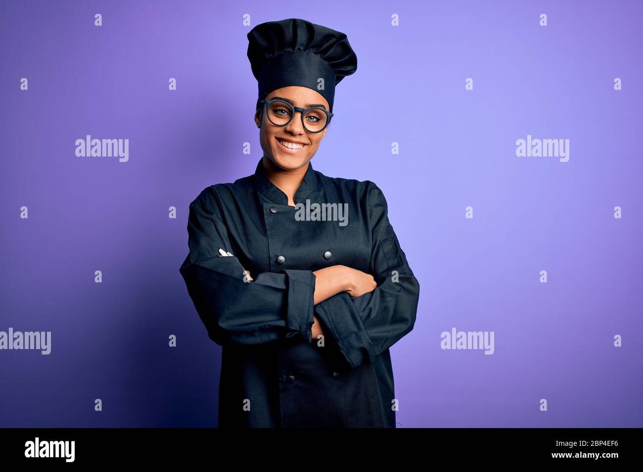 Young african american chef girl wearing cooker uniform and hat over ...