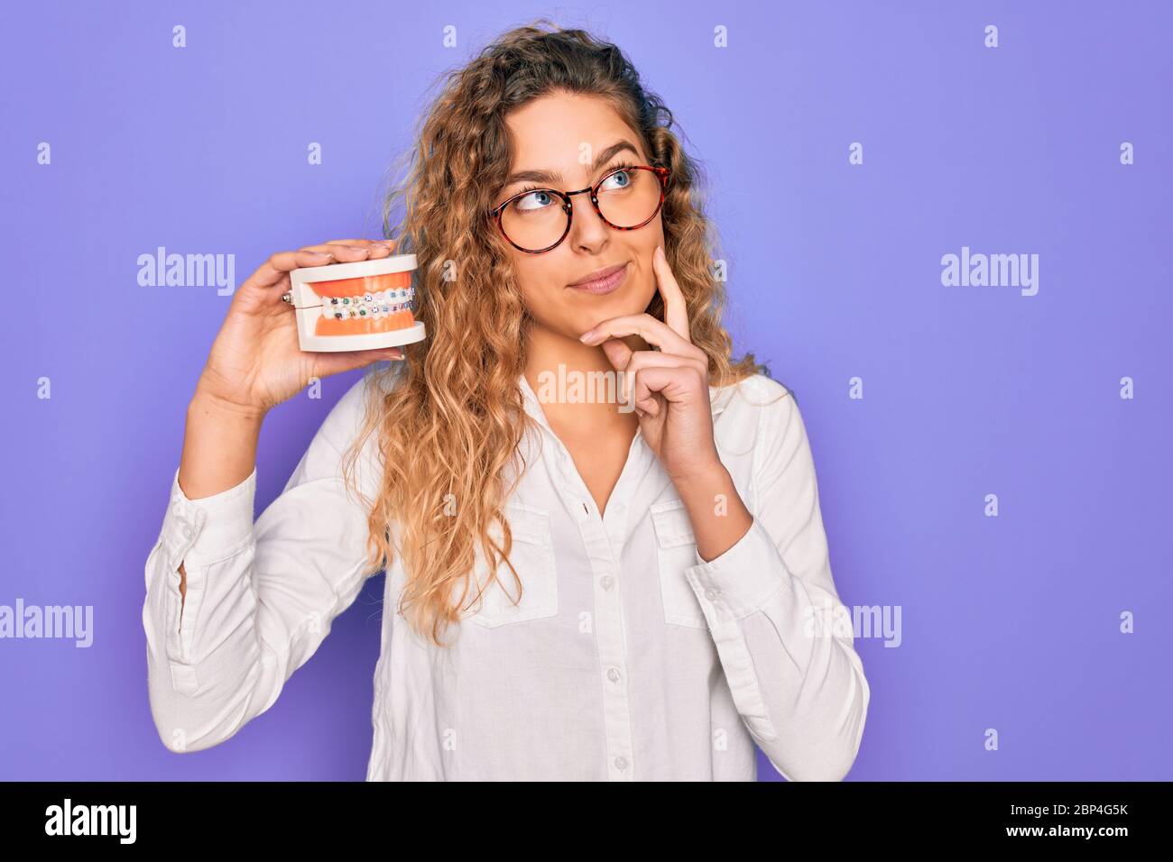 Woman hand over mouth thoughtful hi-res stock photography and images ...