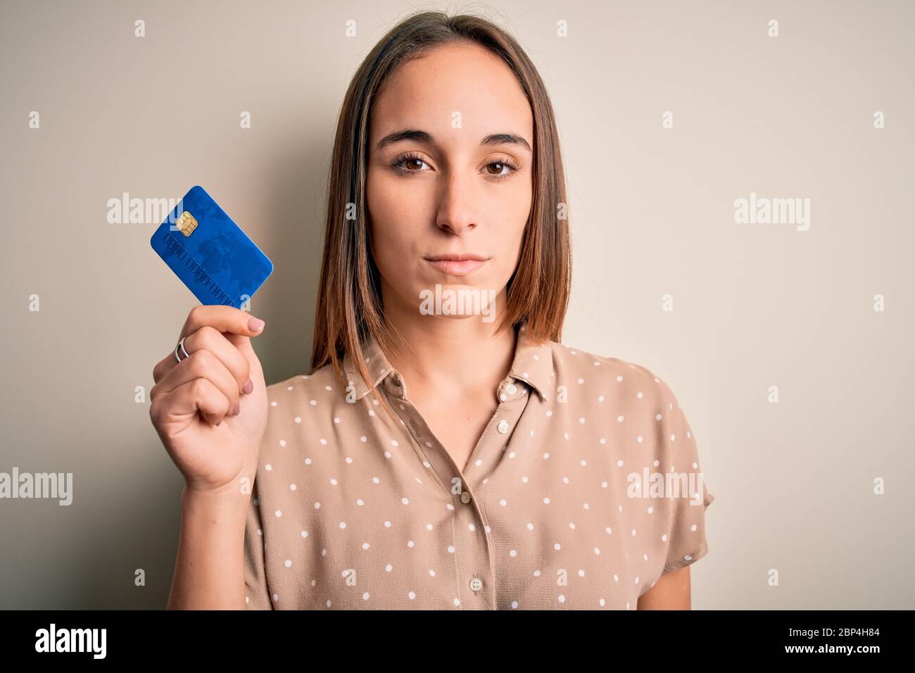Young beautiful customer woman holding credit card to do payment over ...