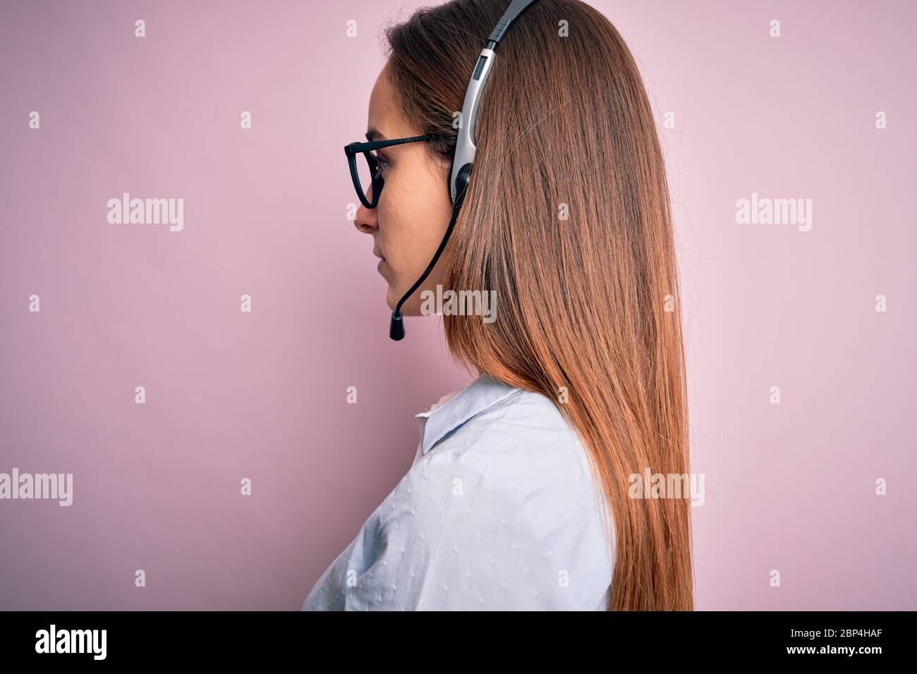 Young beautiful call center agent woman wearing glasses working using ...