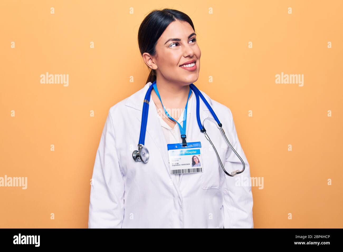 Young beautiful doctor woman wearing stethoscope and id card over ...