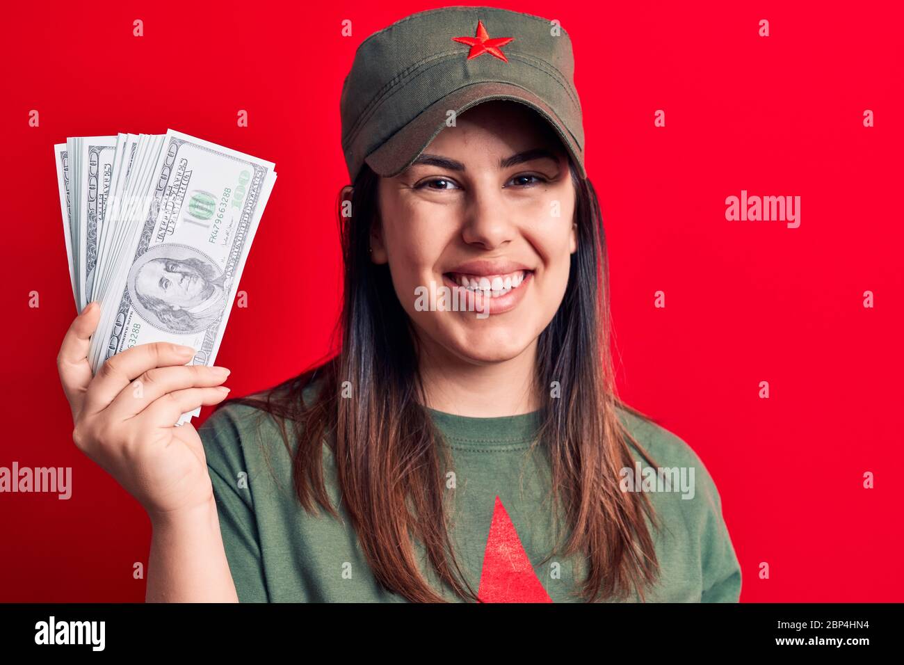 Woman wearing t-shirt with red star communist symbol holding bunch of ...