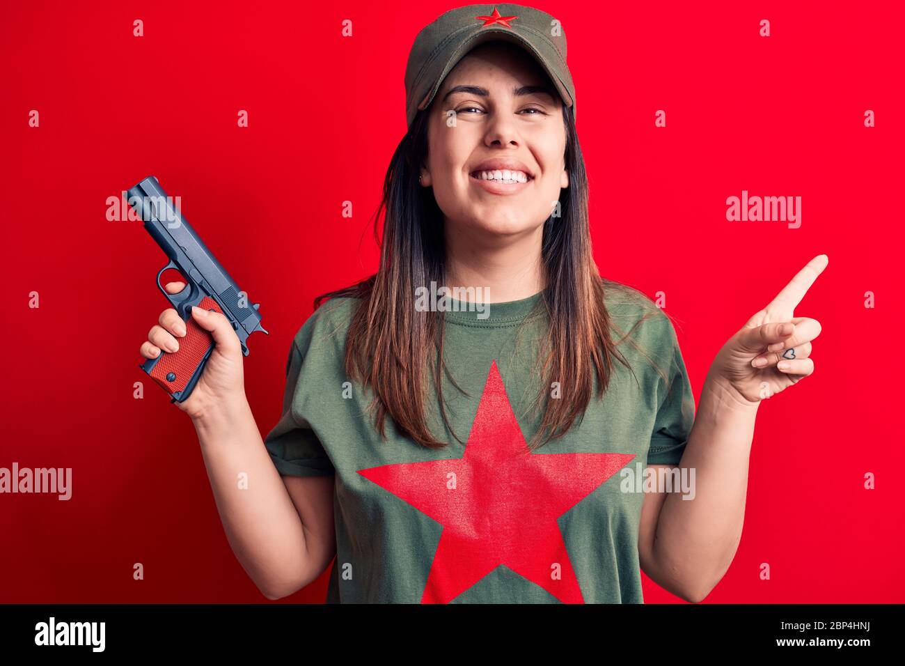 Young beautiful brunette woman wearing t-shirt with red star communist ...