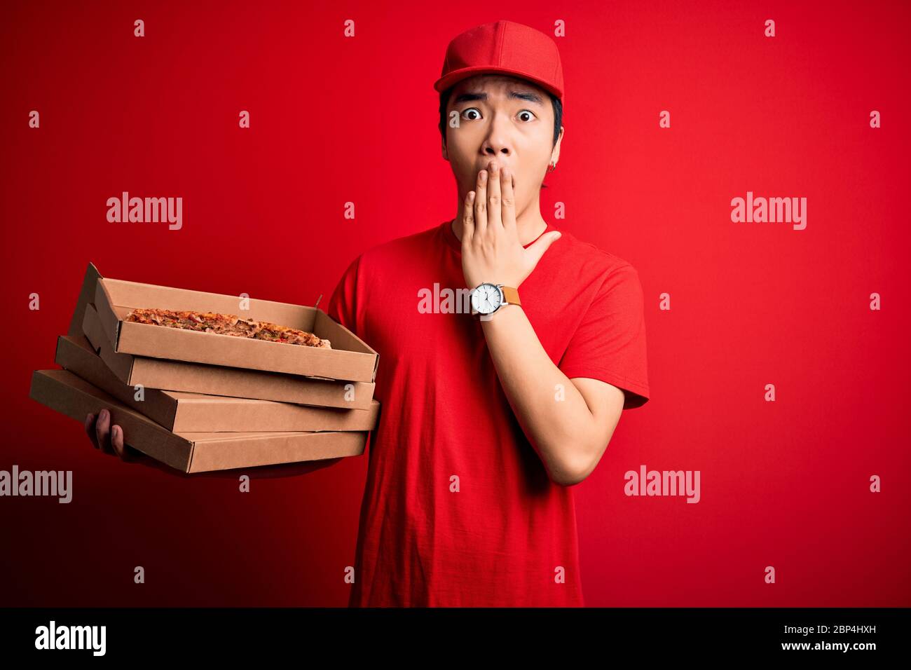 Young handsome chinese delivery man holding deliver boxes with Italian ...