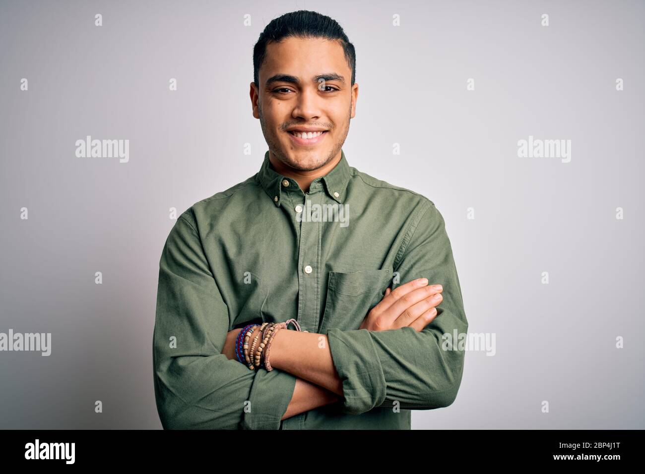 Young brazilian man wearing casual shirt standing over isolated white ...