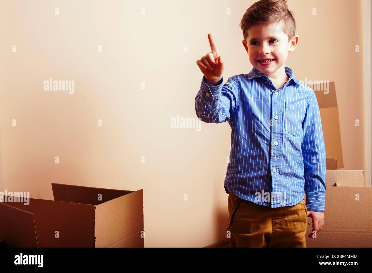 little cute boy in empty room, move to new house. home alone among ...