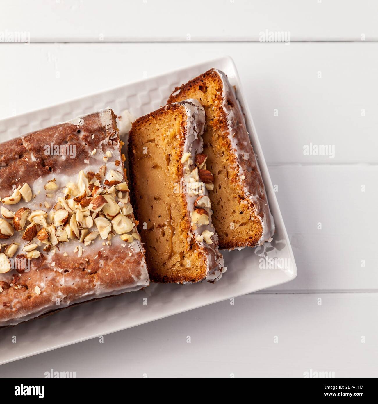 Banana loaf cake with nuts on top cut open wooden table top view Stock ...