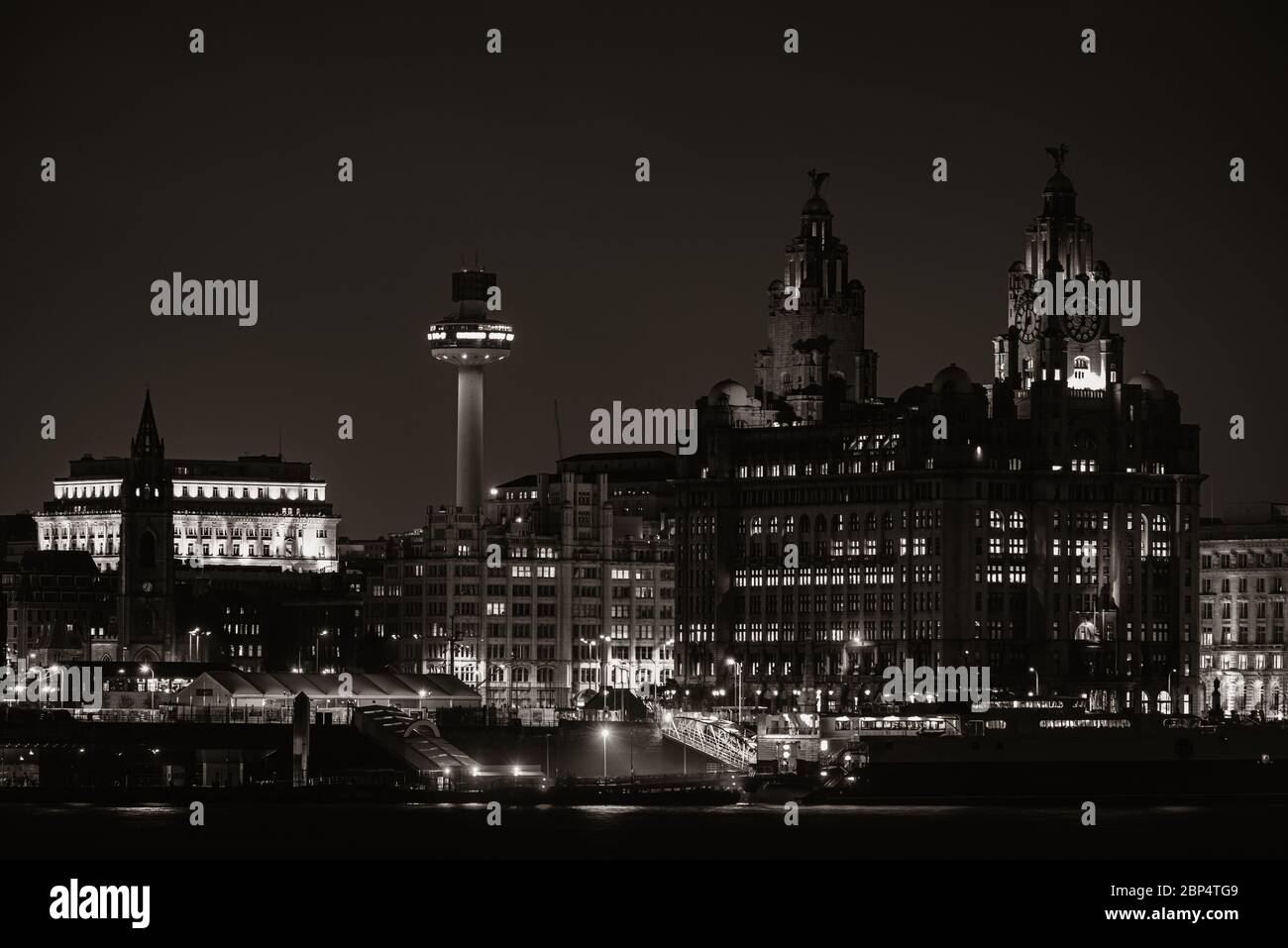 Liverpool Royal Liver Building at night with buildings in England in ...