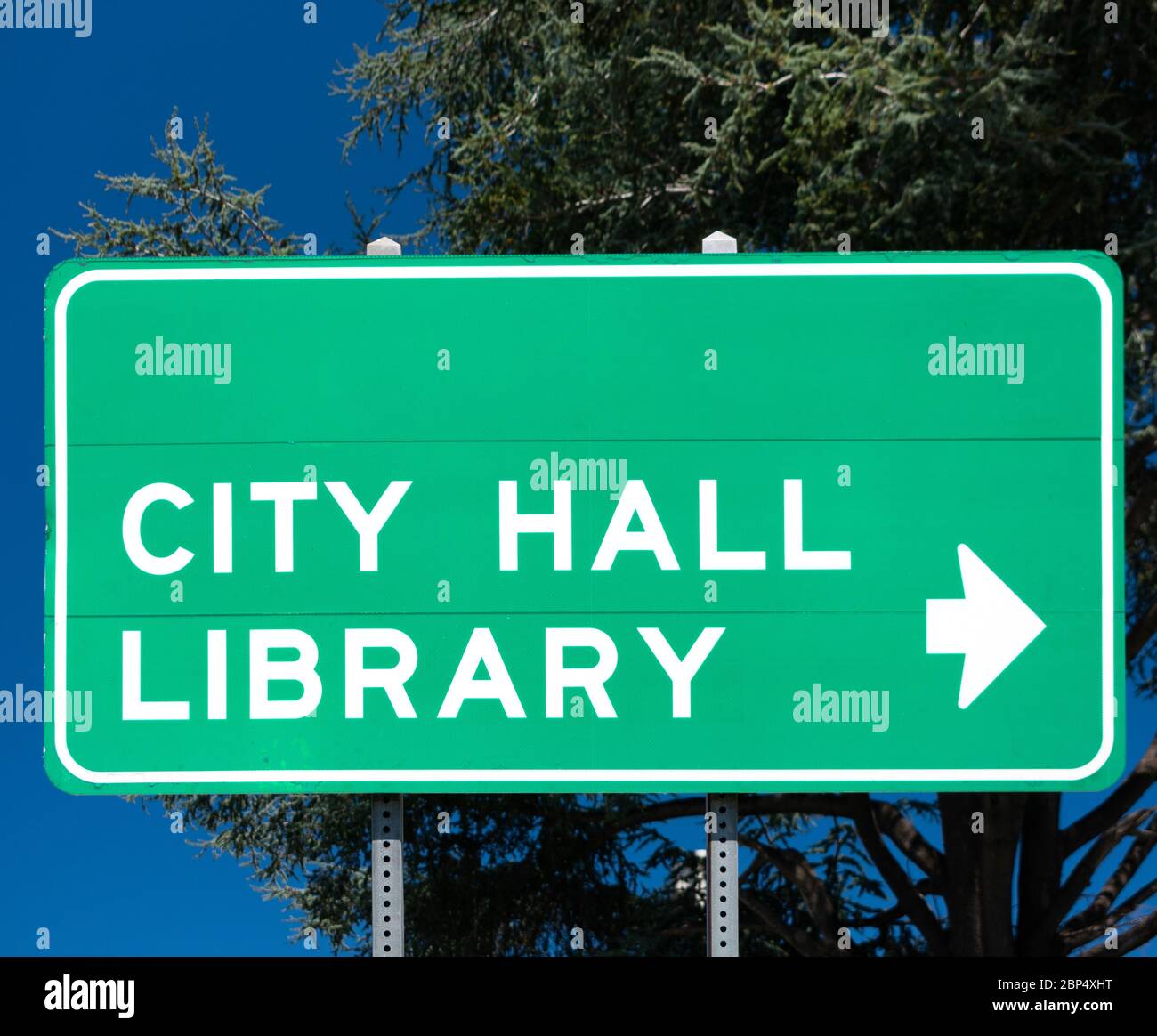 City Hall and Library green guide road sign with white lettering and ...