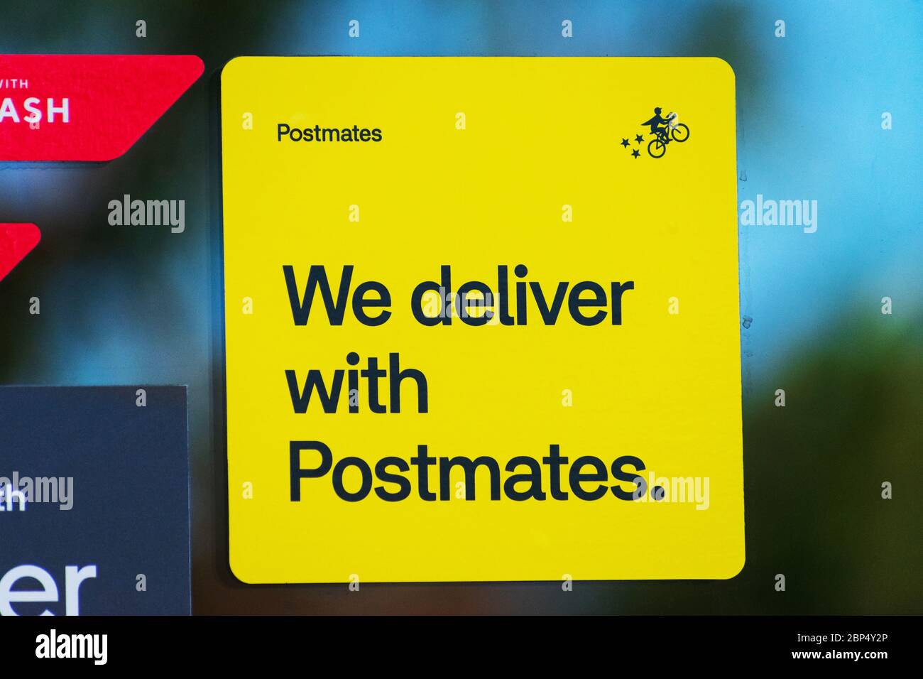 Close up. A yellow sticker decal advertising delivery service available ...