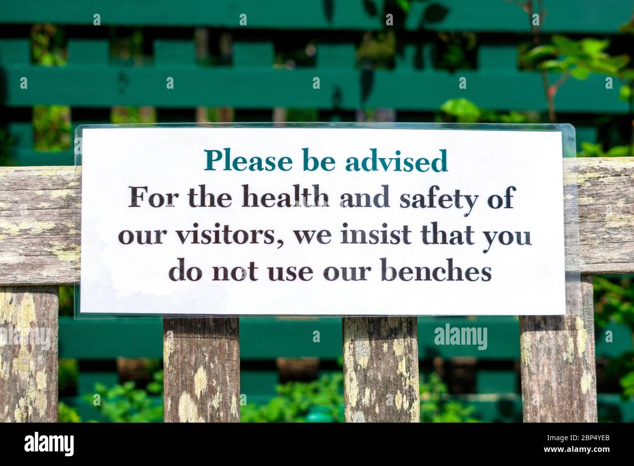 Notice informing public park visitors do not use benches for health and ...