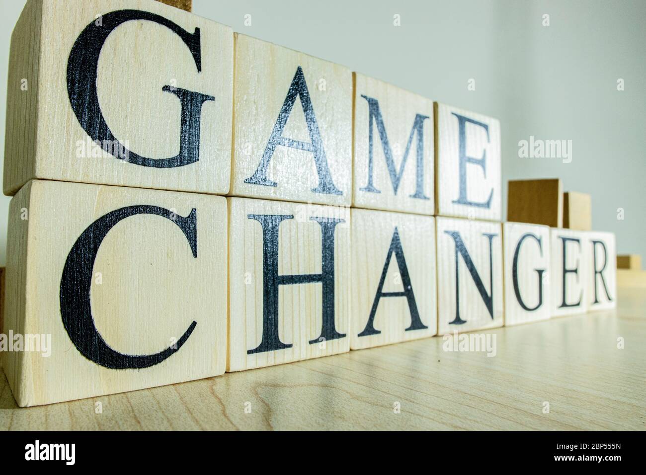 Game changer text on wooden cube blocks. Close up Stock Photo - Alamy