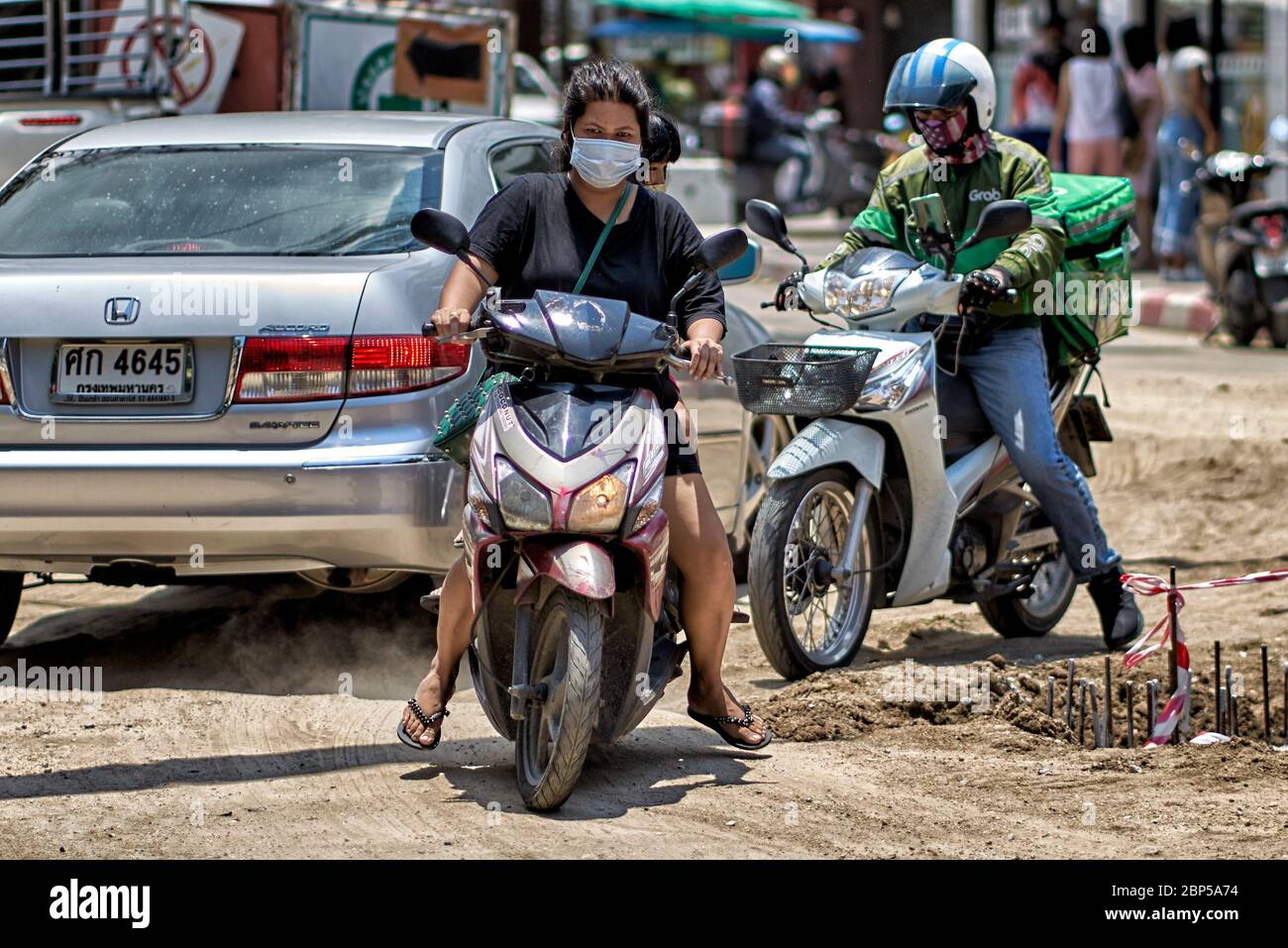 Woman riding a motorcycle and navigating treacherous road conditions ...