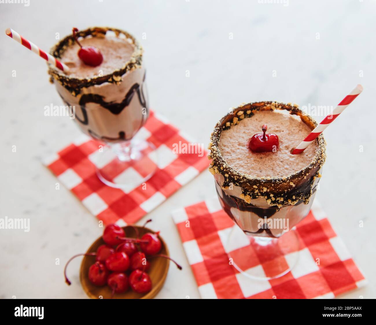 Chocolate milkshake with cherry and graham cracker garnish Stock Photo ...
