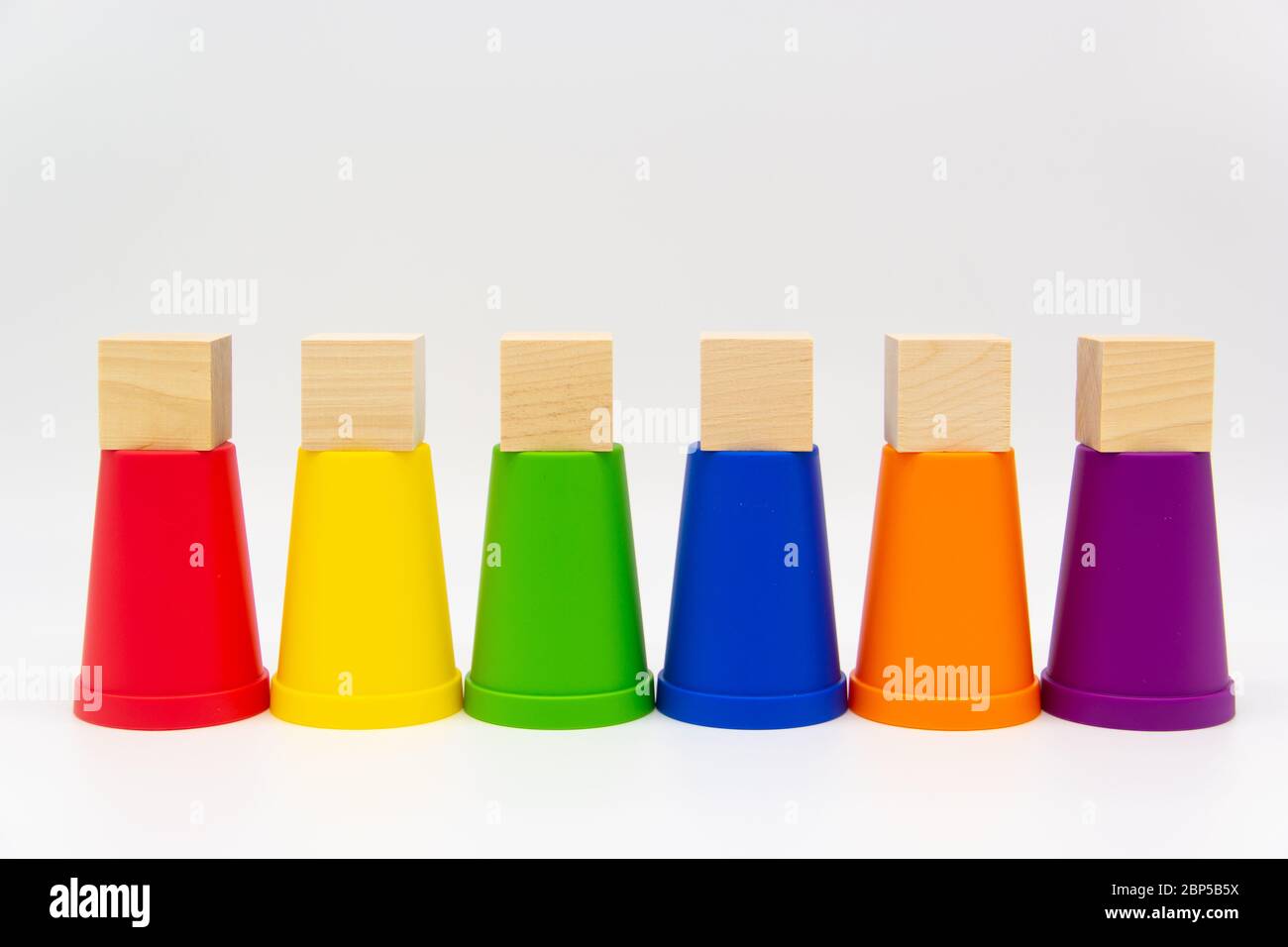 Rainbow cups with blank word blocks. A colorful representation of equal ...