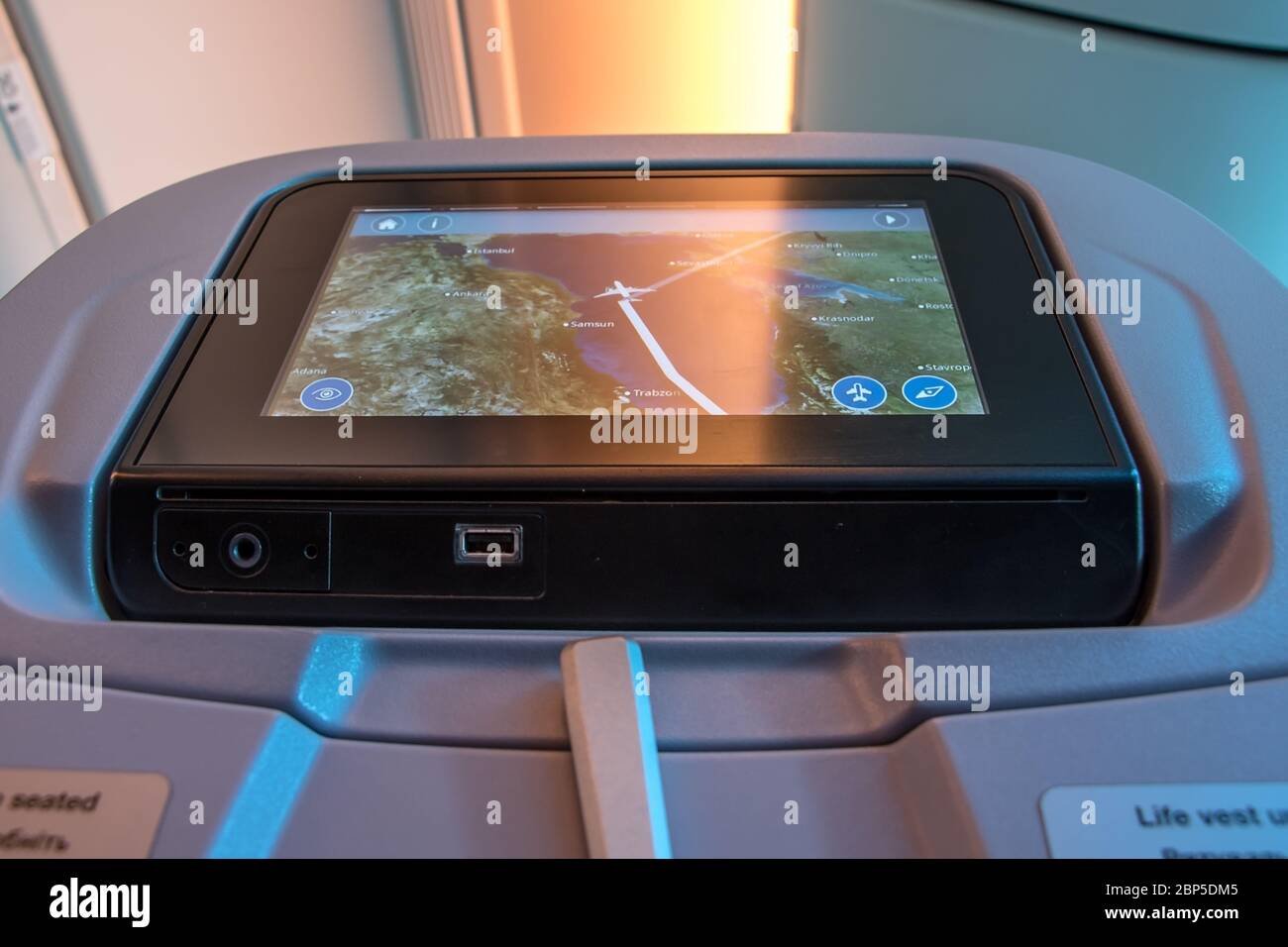 Display with maps in a flying aircraft. A monitor on backside of chair ...