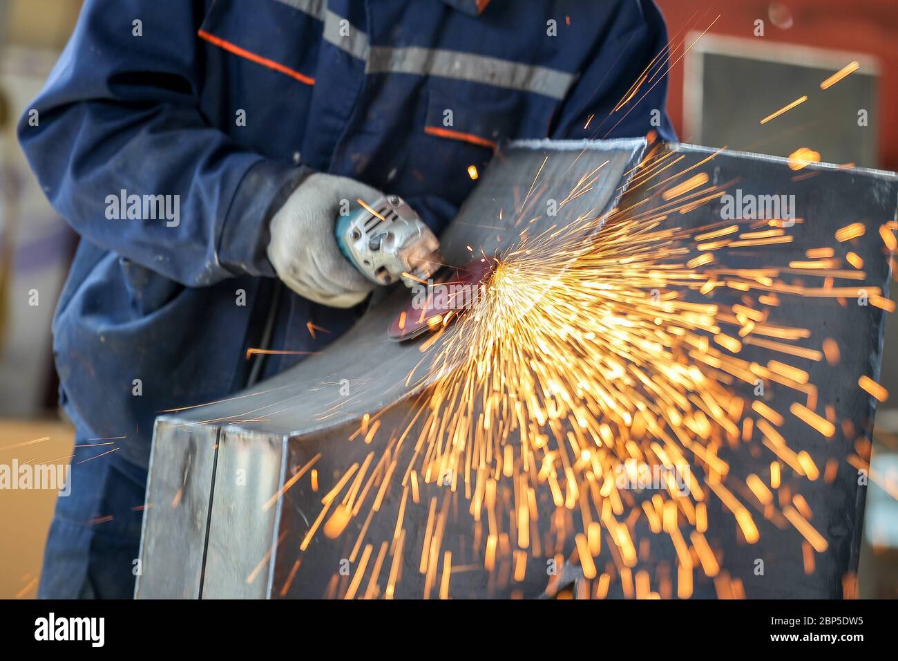 Master grind metal a grinder sparks Stock Photo - Alamy