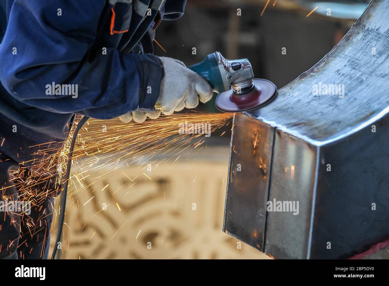 Master grind metal a grinder sparks Stock Photo - Alamy