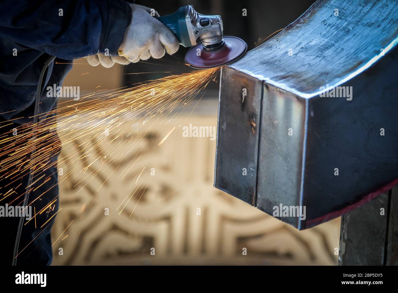 Master grind metal a grinder sparks Stock Photo - Alamy