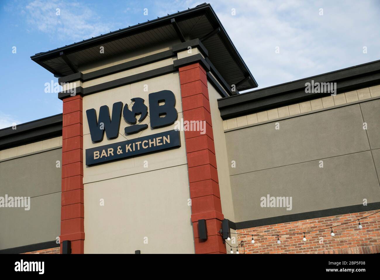 A logo sign outside of a World of Beer (WOB) restaurant location in ...