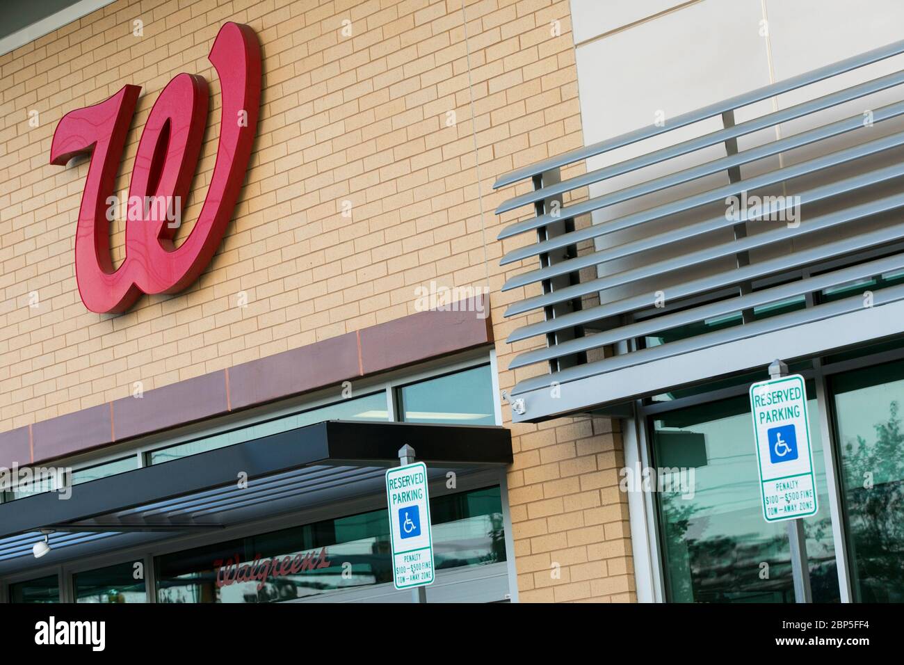 A logo sign outside of a Walgreens Pharmacy store location in Richmond ...