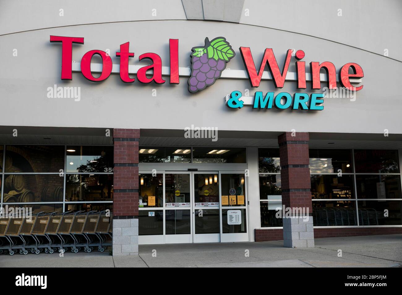 A logo sign outside of a Total Wine & More retail store location in ...