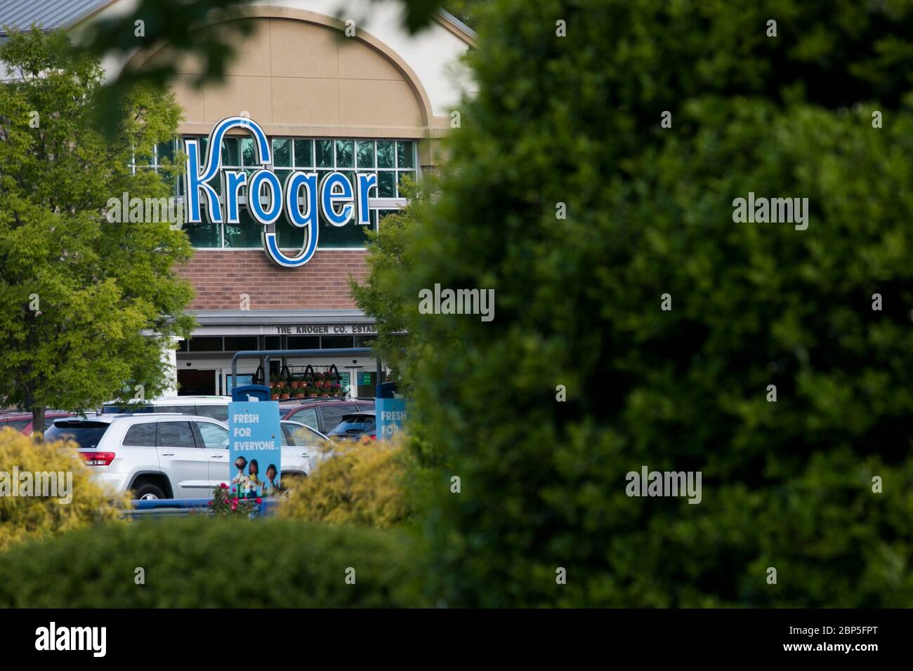 A logo sign outside of a Kroger retail grocery store location in ...