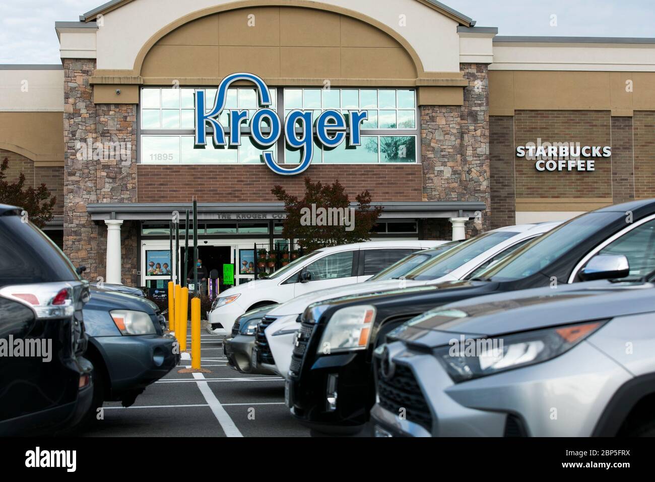 A logo sign outside of a Kroger retail grocery store location in ...