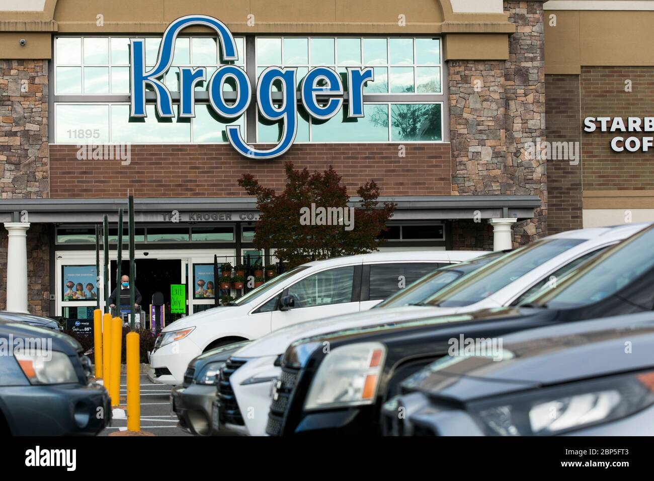 A logo sign outside of a Kroger retail grocery store location in ...