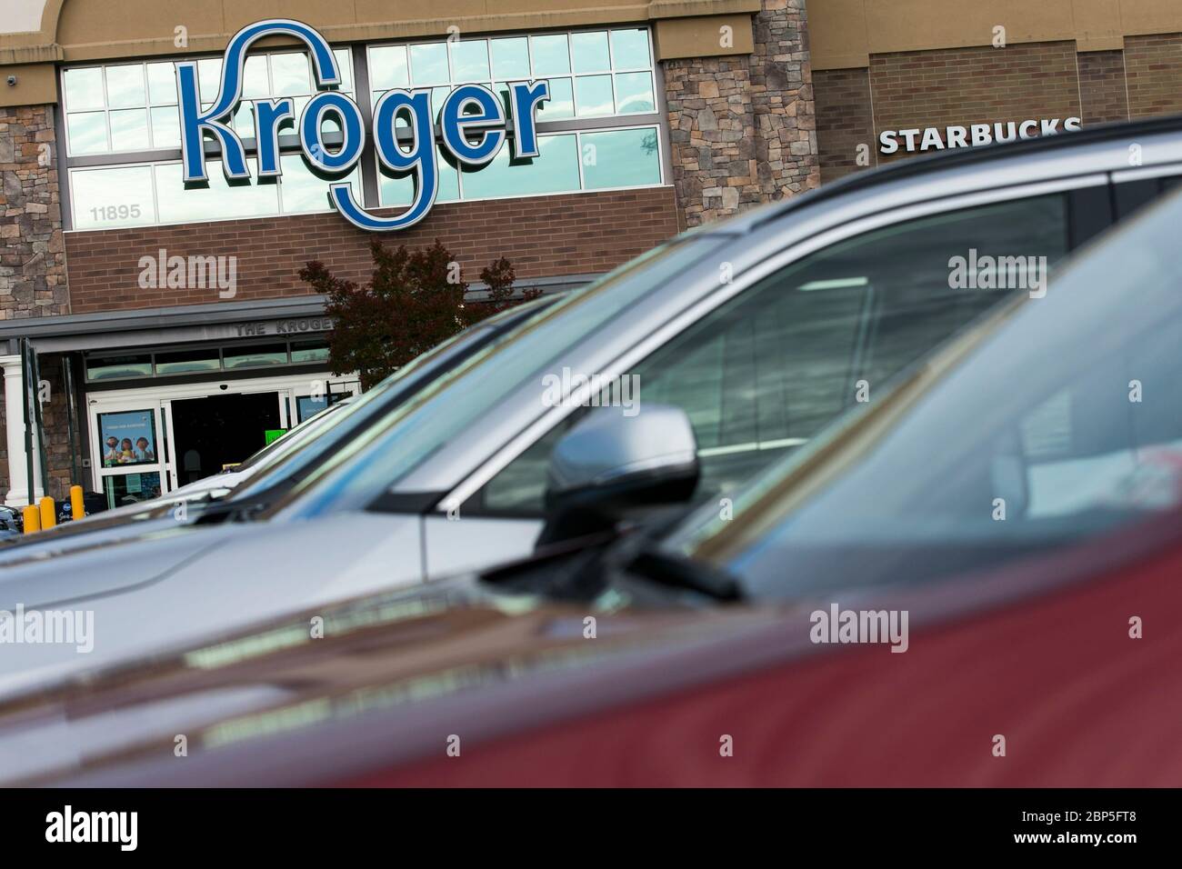 A logo sign outside of a Kroger retail grocery store location in ...