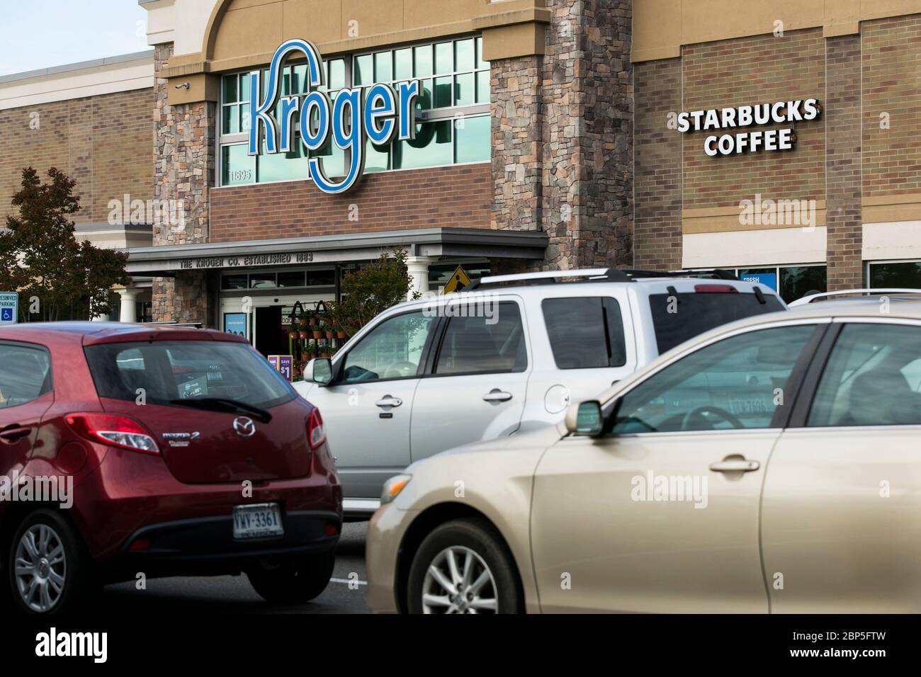 A logo sign outside of a Kroger retail grocery store location in ...