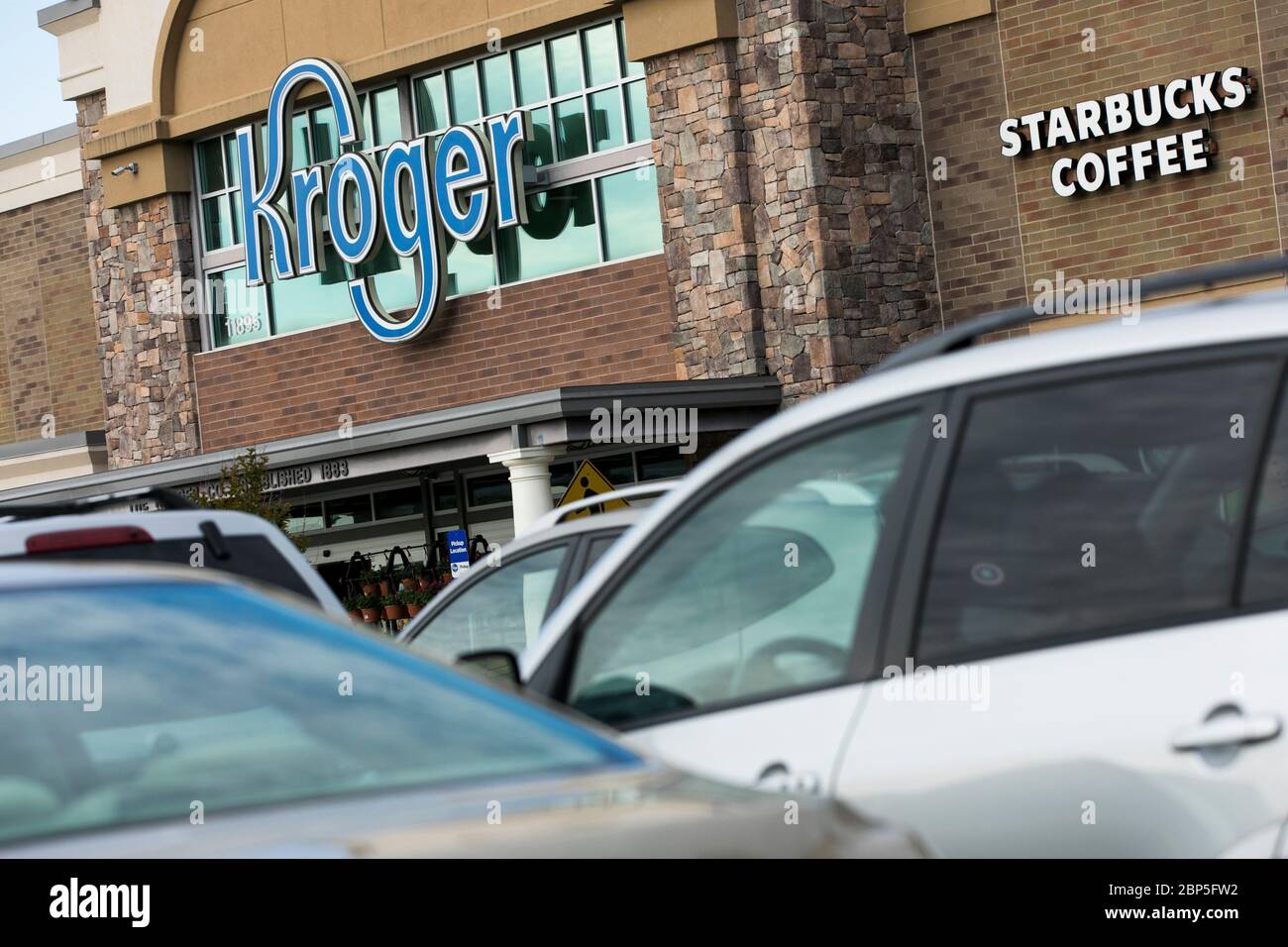 A logo sign outside of a Kroger retail grocery store location in ...