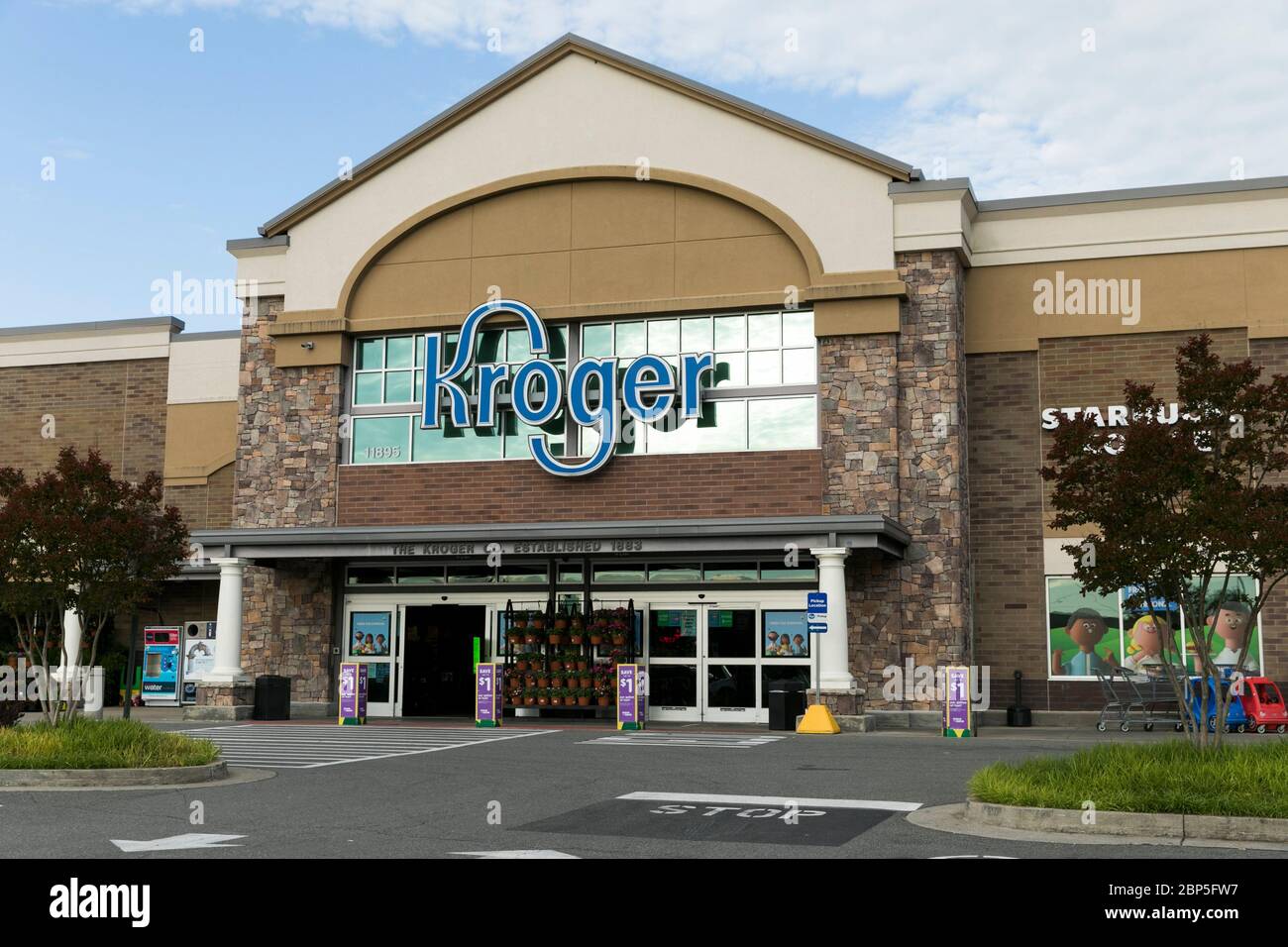 A logo sign outside of a Kroger retail grocery store location in ...