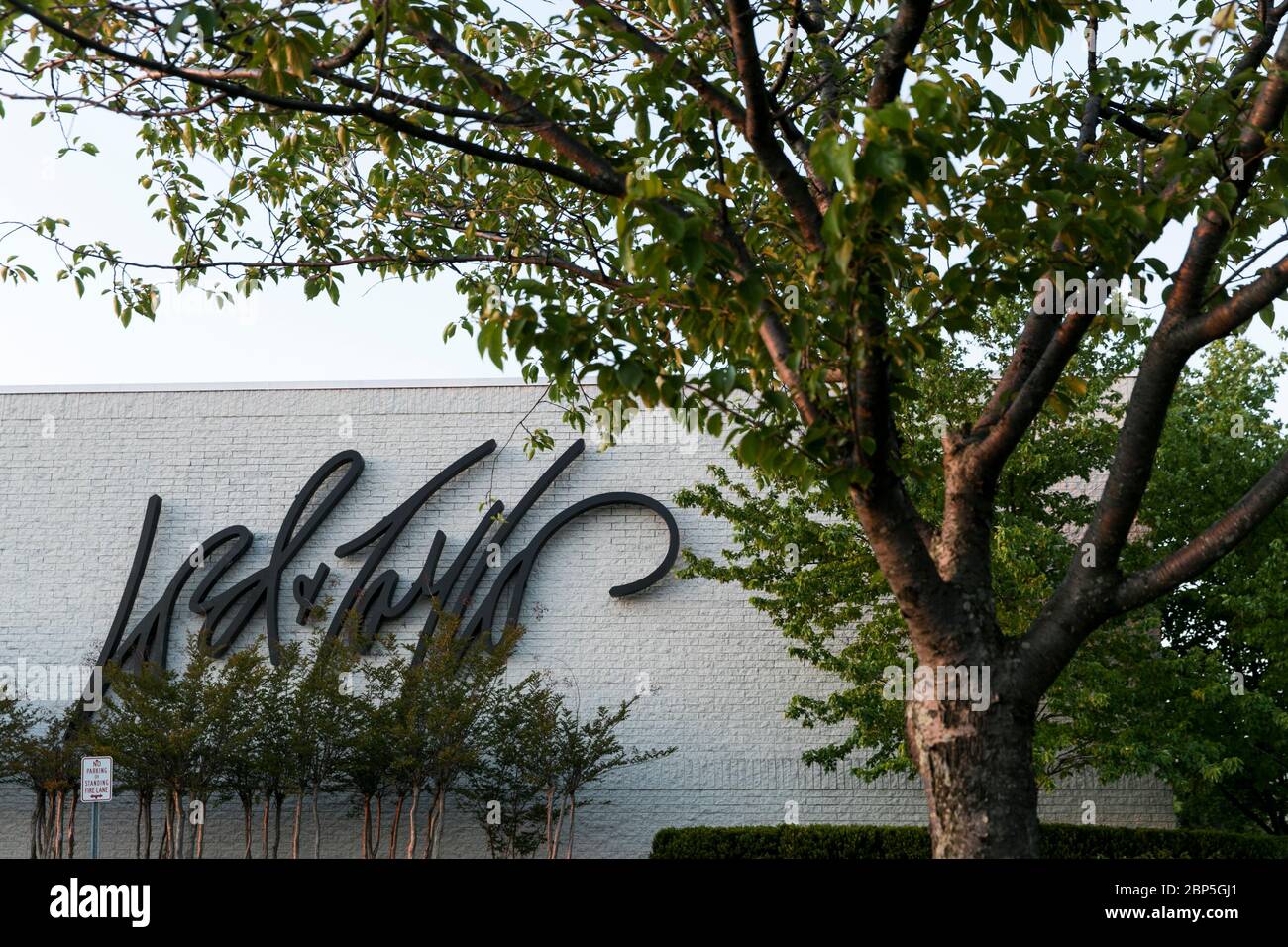 A logo sign outside of a Lord & Taylor retail store location in ...