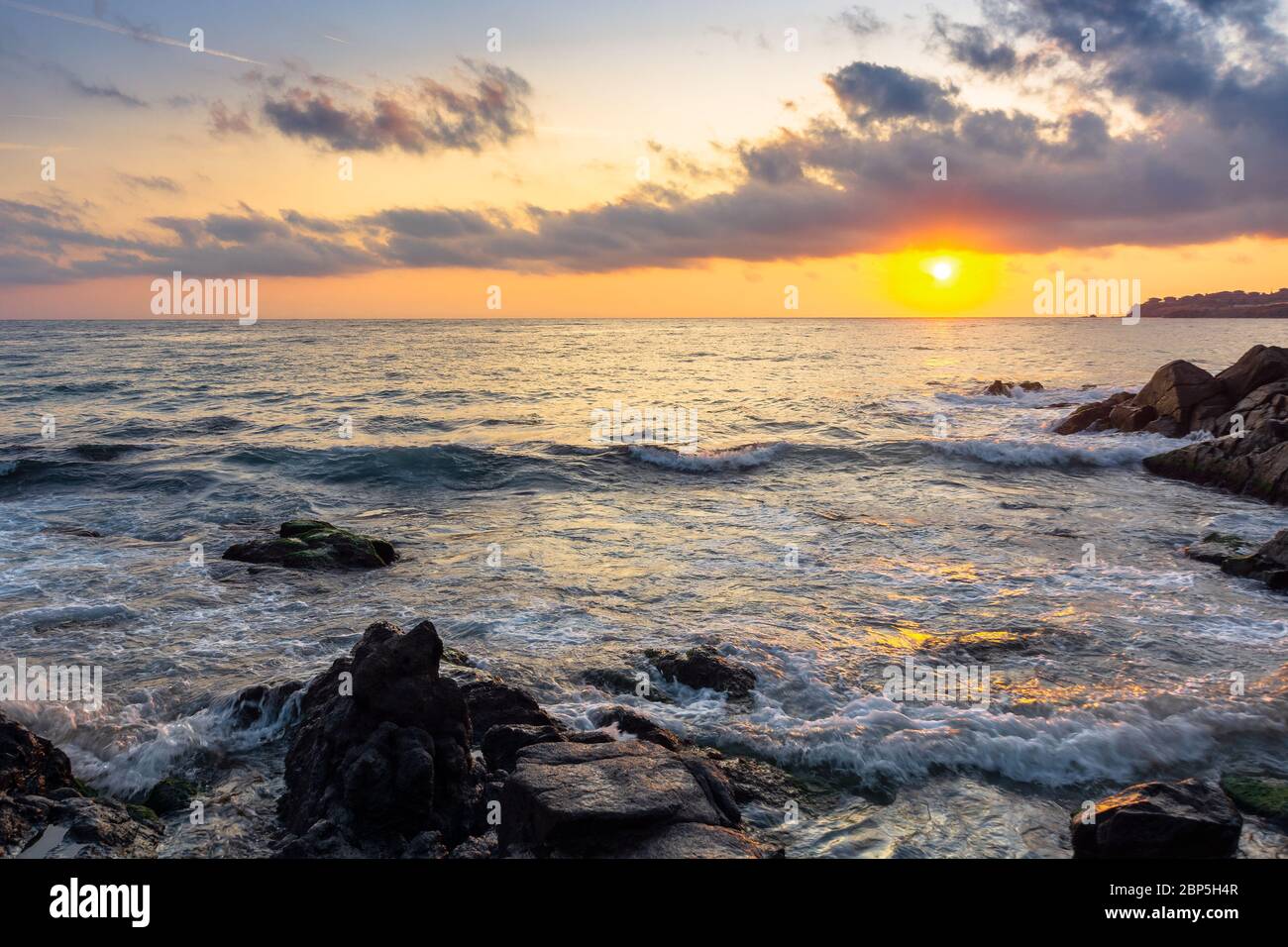 coast of the ocean at sunset. beautiful landscape with rocks in the ...