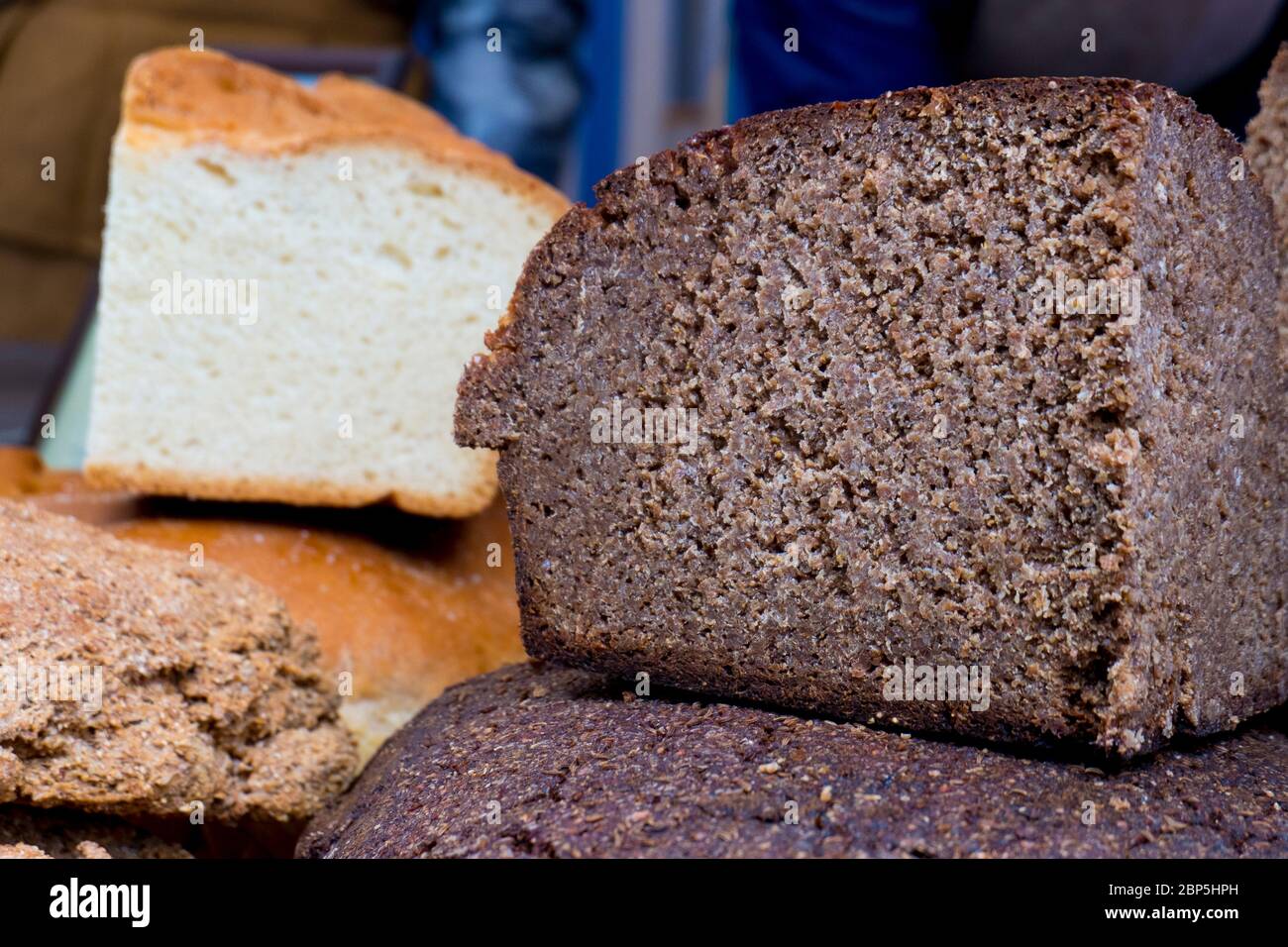 A stall sells the classic dark and light local, homemade heavy bread ...