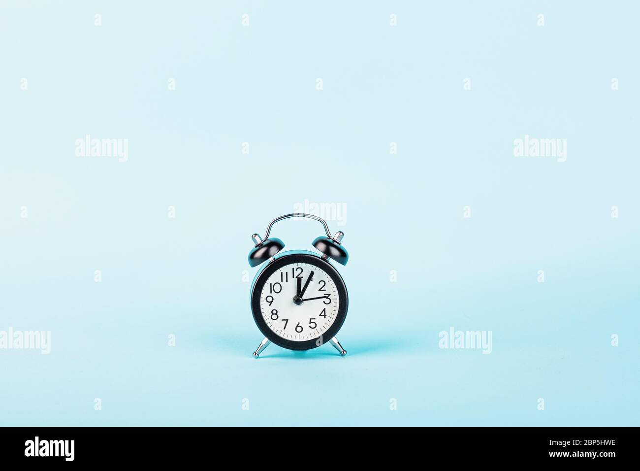 Retro alarm clock on blue background. Mockup, template. Time for work ...